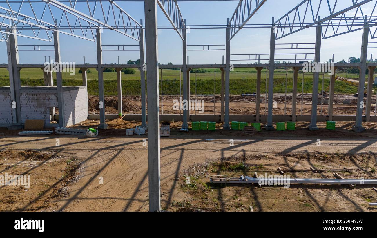 A construction site with steel framework and concrete columns for a ...