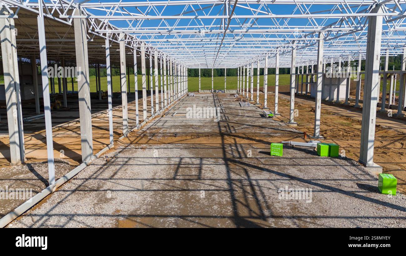 A large industrial warehouse under construction with steel framework ...