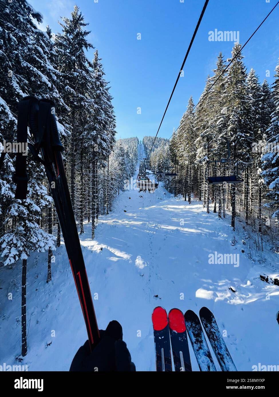Experience a breathtaking ski lift journey above snowy terrain ...