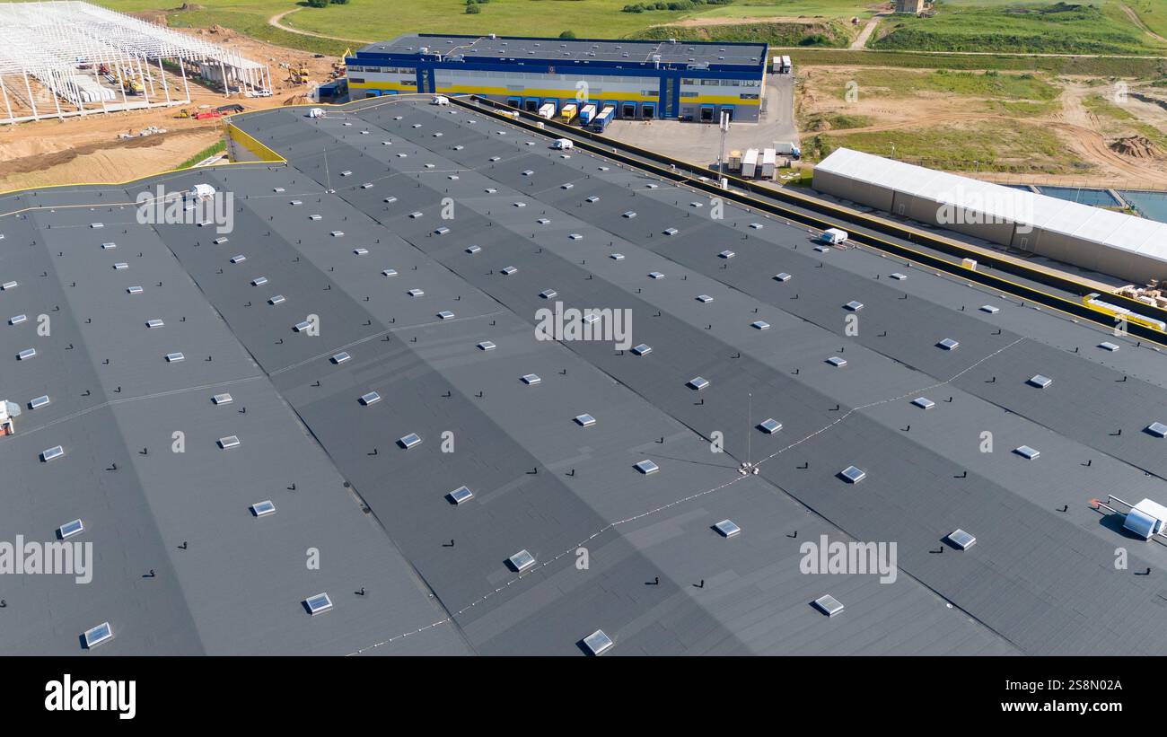 Aerial view of a large industrial warehouse with a flat roof and ...