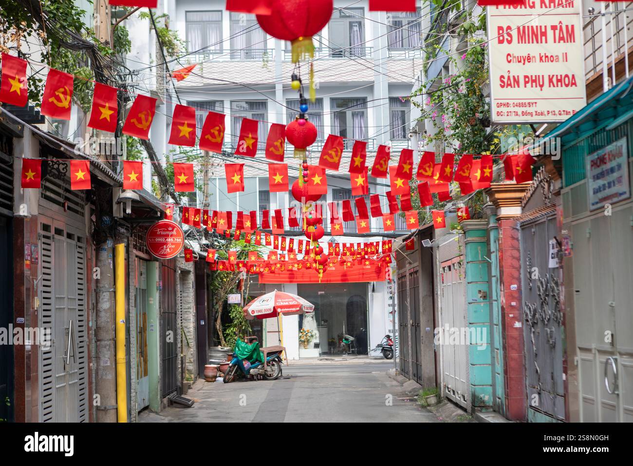 Vietnamese and Communist flags in a small street for Tet in Ho Chi Minh ...