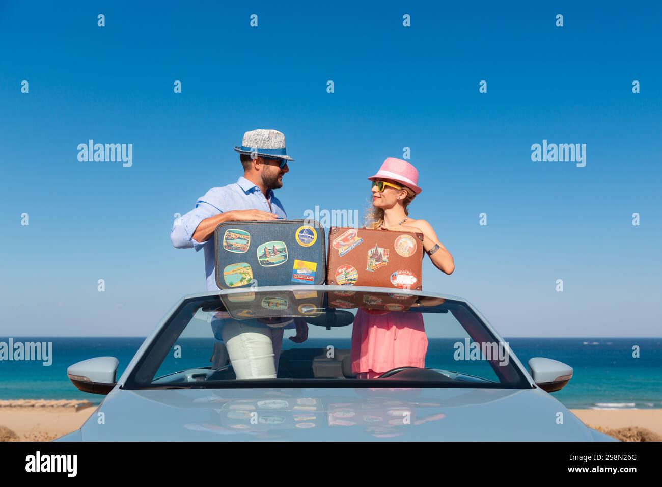 Happy couple in love travel by car by the sea. Young man and woman ...