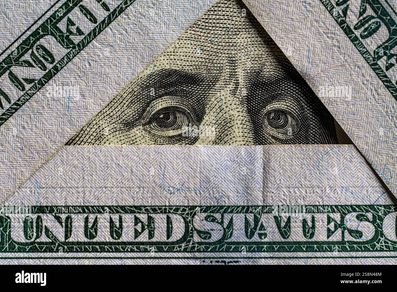 President of Benjamin Franklin's eyes in a triangle of hundred dollar ...