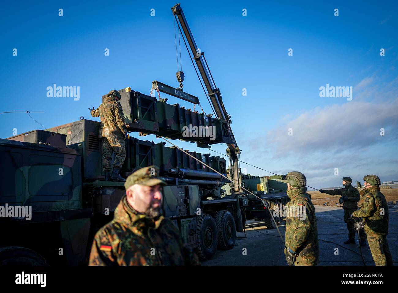 23 January 2025, Poland, Rzeszow: Bundeswehr soldiers load missiles for ...