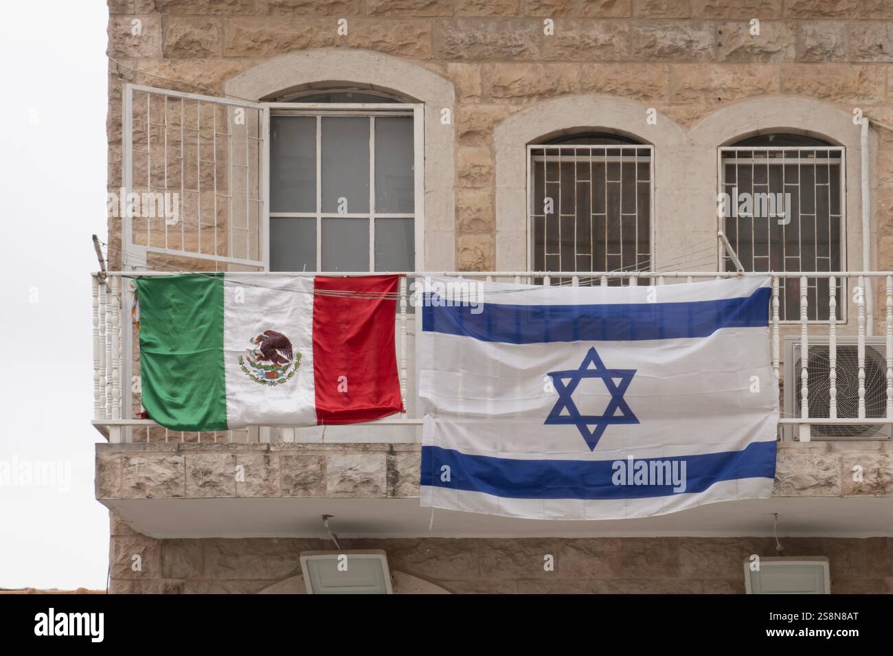The Israeli and Mexican flag hang outside a residential house in ...