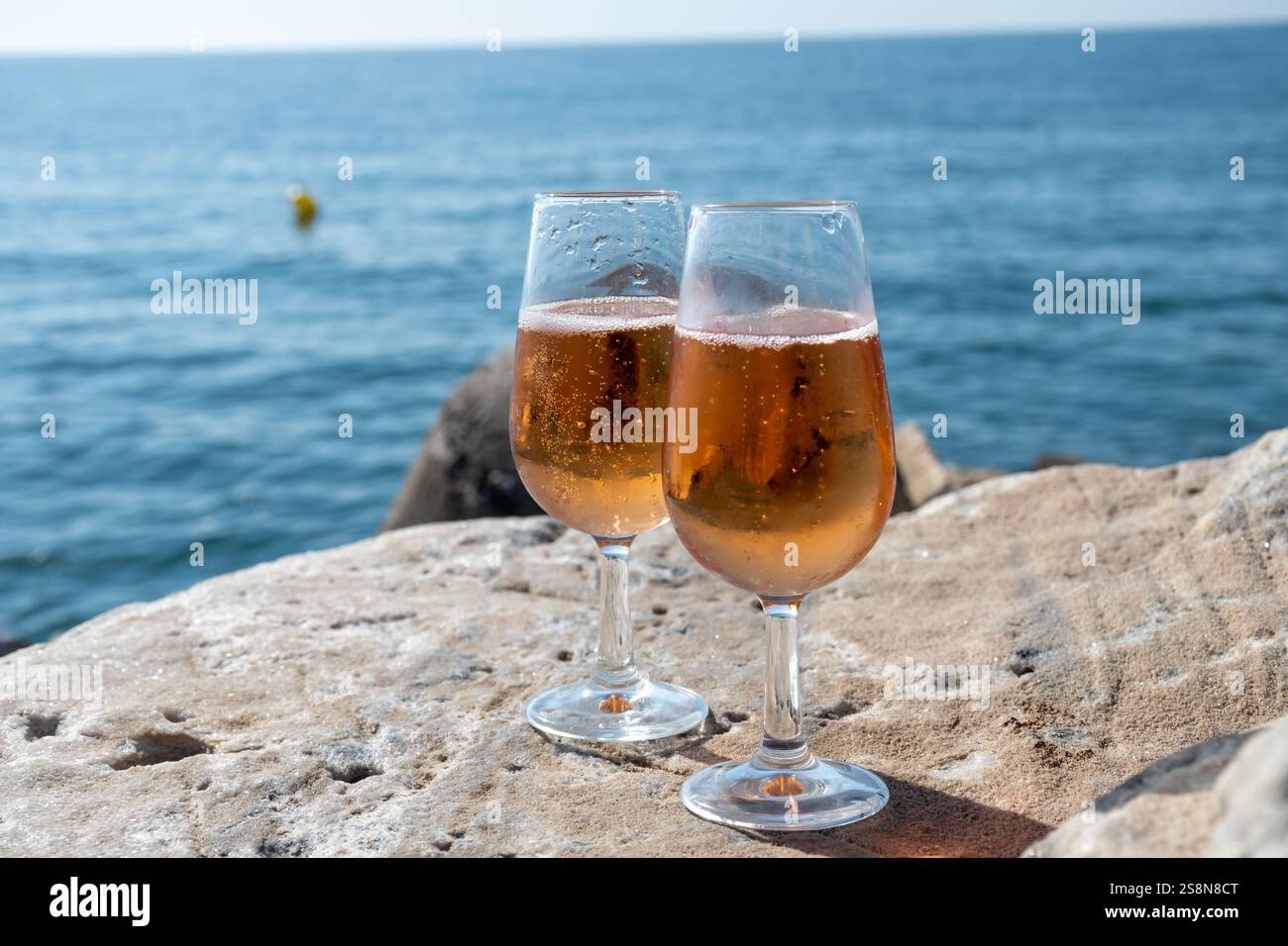 Drinking rose champagne or cava sparkling wine in Puerto Banus in ...