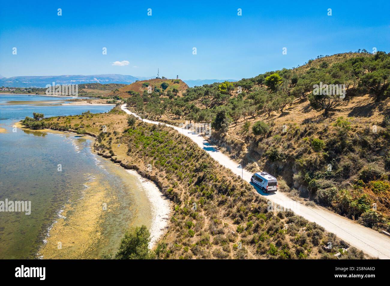 Camper van, RV or motor home is driving on gravel road from Zvernec ...