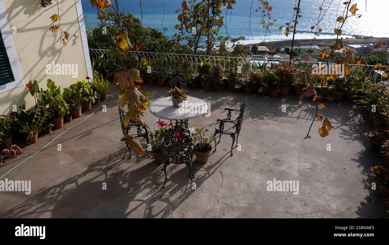 A scenic terrace overlooking the ocean, featuring wrought iron ...