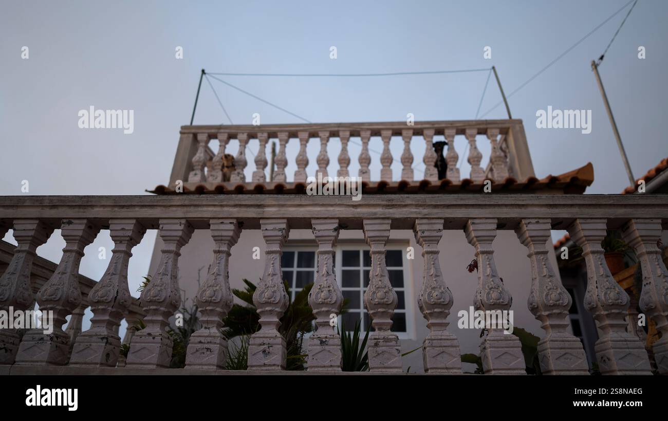 A Mediterranean-style house with ornate white balustrades on the ...