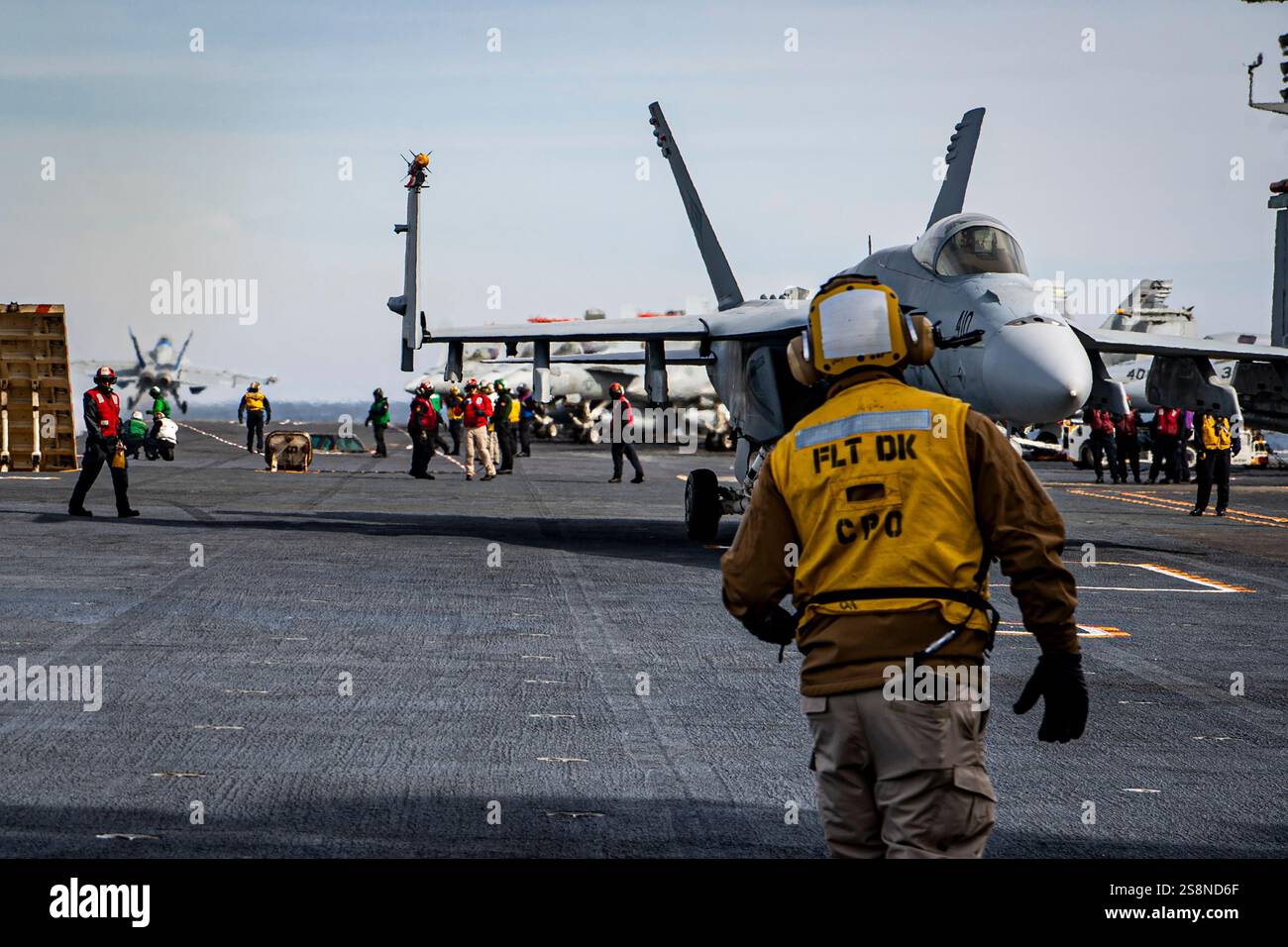 Sailors observe flight operations on the flight deck of the aircraft ...