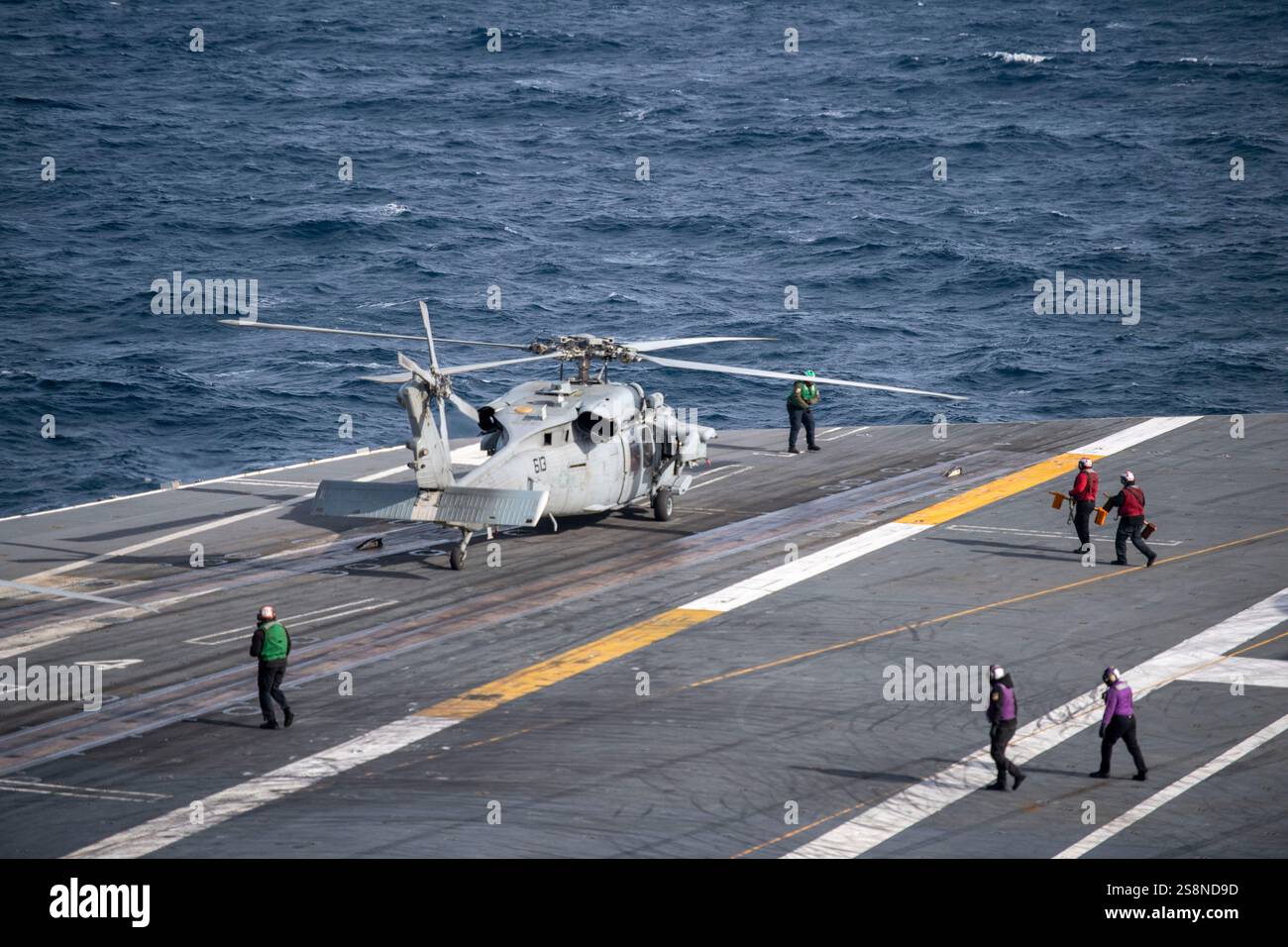 Sailors prepare an MH-60S Sea Hawk helicopter from the “Screamin ...