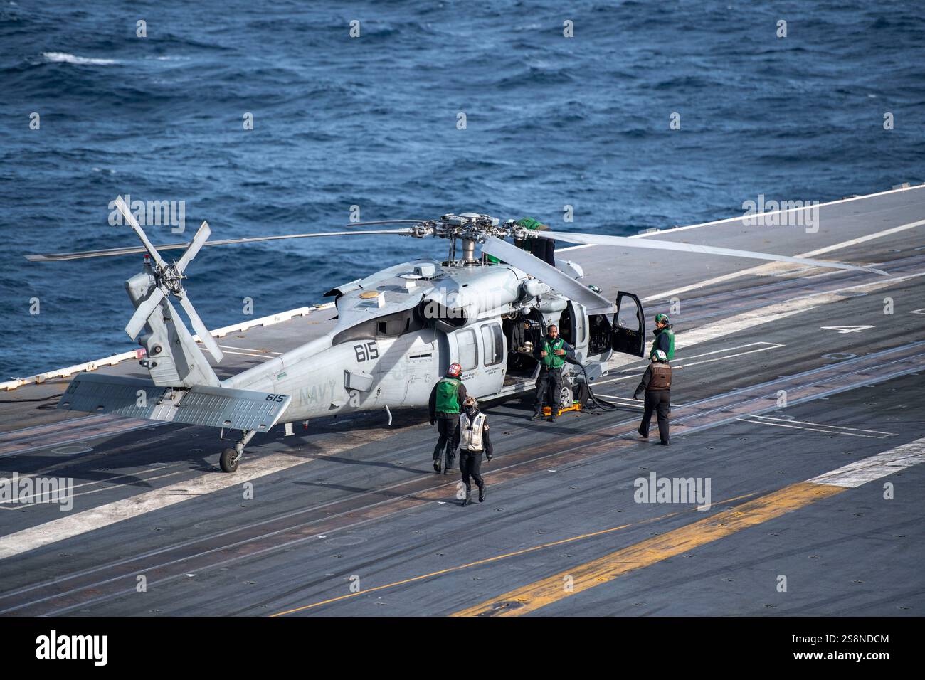 Sailors prepare an MH-60S Sea Hawk helicopter from the “Screamin ...
