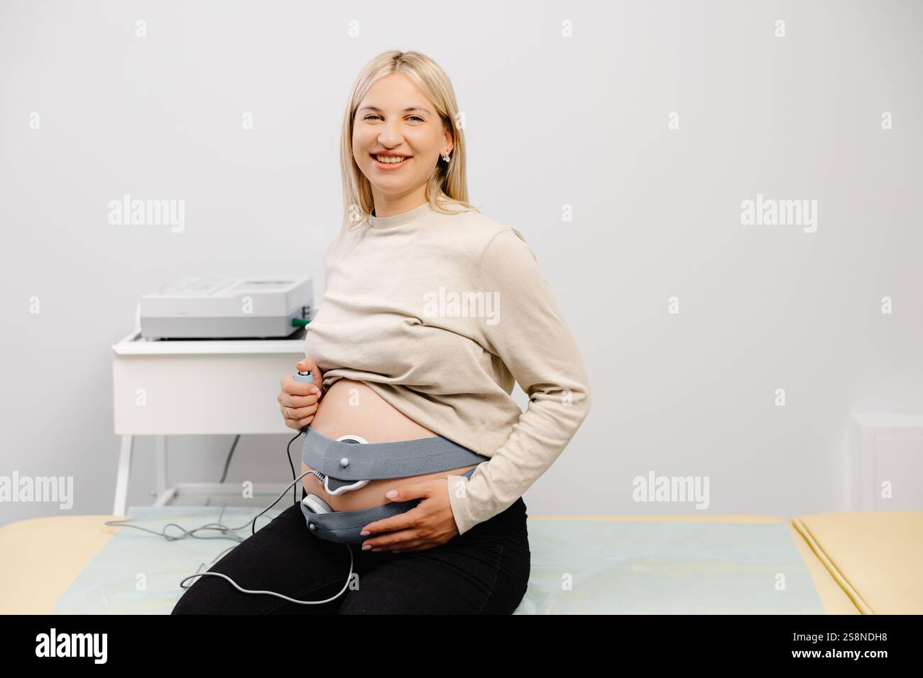 Woman pregnant checking fetal heart beat by fetal monitoring. Expectant ...