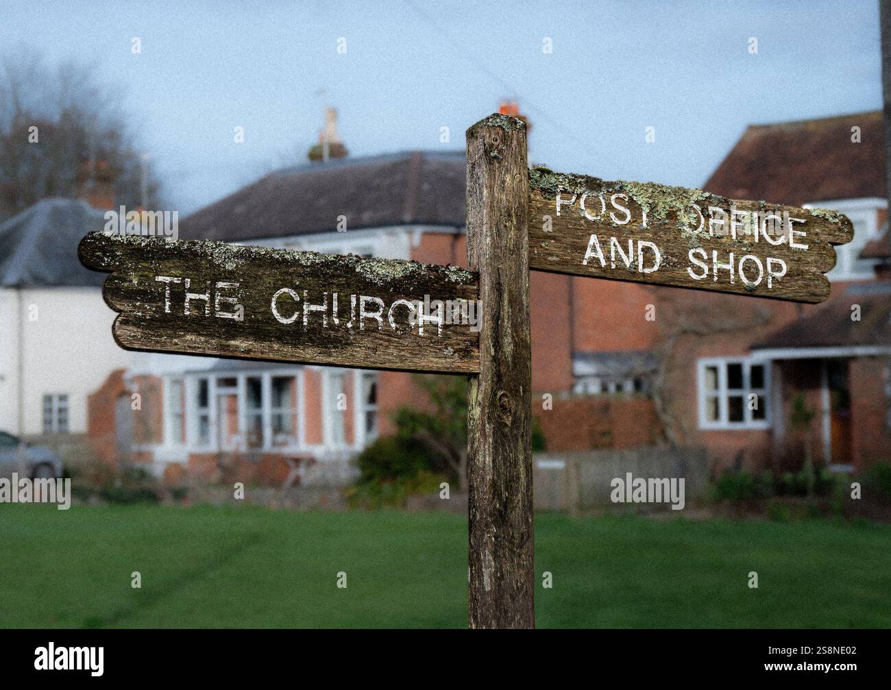 An old wooden signpost showing the direction of the church, post office ...