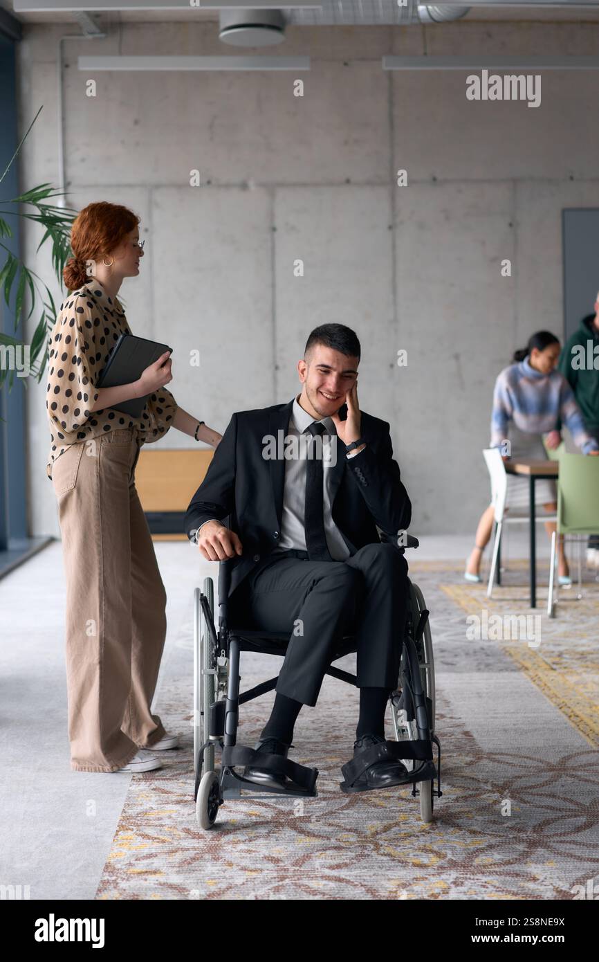 A business director in a wheelchair moves confidently through a modern ...