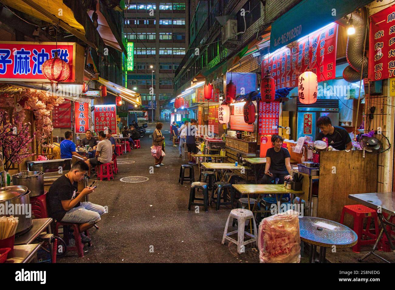 TAIPEI, TAIWAN - DECEMBER 4, 2018: People visit Raohe Street Night Market in Taipei. Night food ...