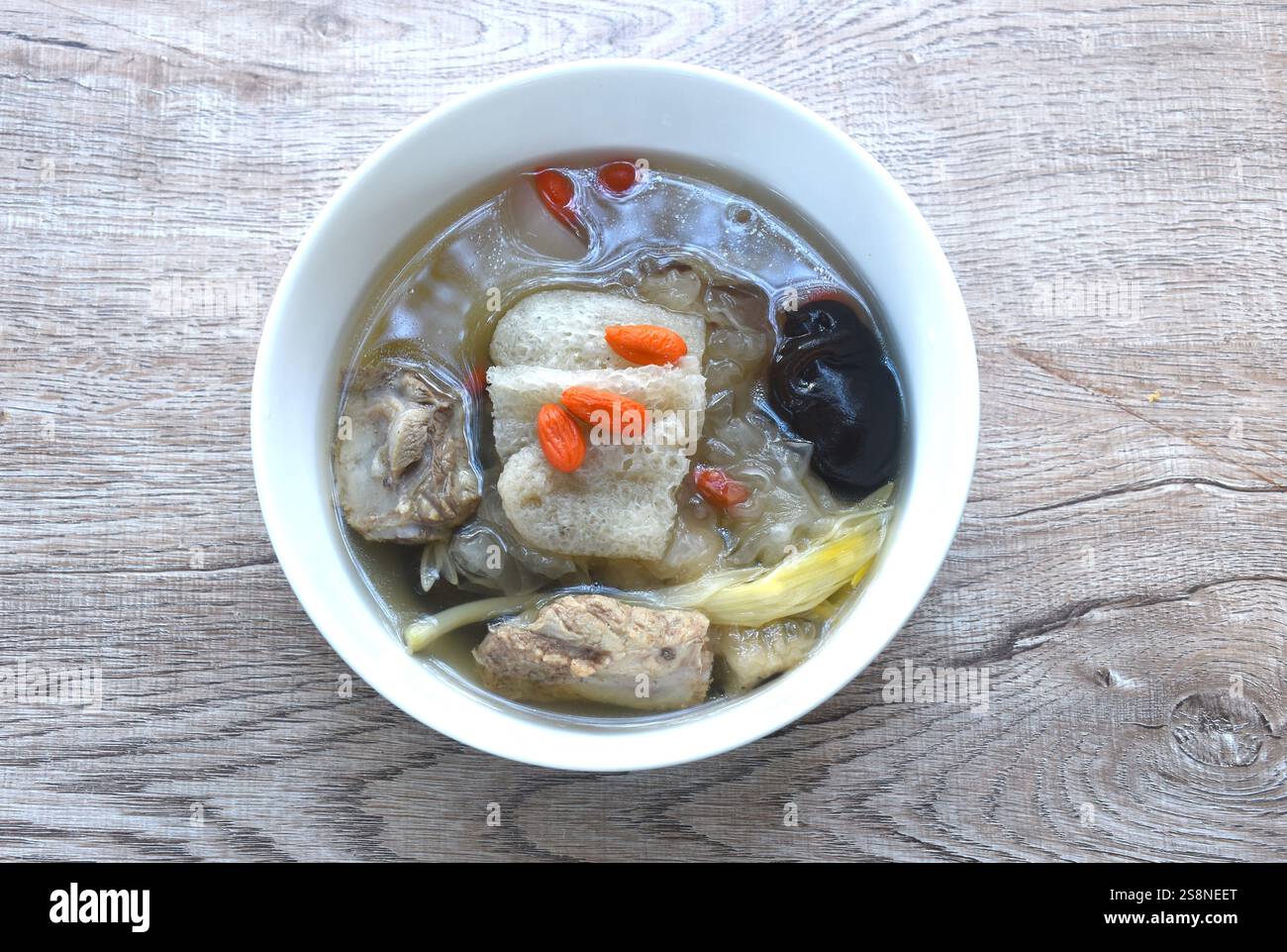boiled bamboo mushroom with pork bone and black ear mushroom in clear ...