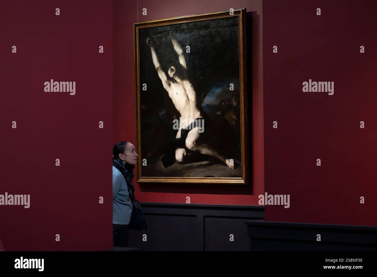A visitor looks at the newly restored painting "Saint Sebastian" by the ...