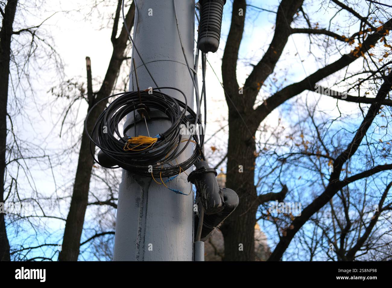 Electrical and internet cables and equipment on utility metal pole in ...
