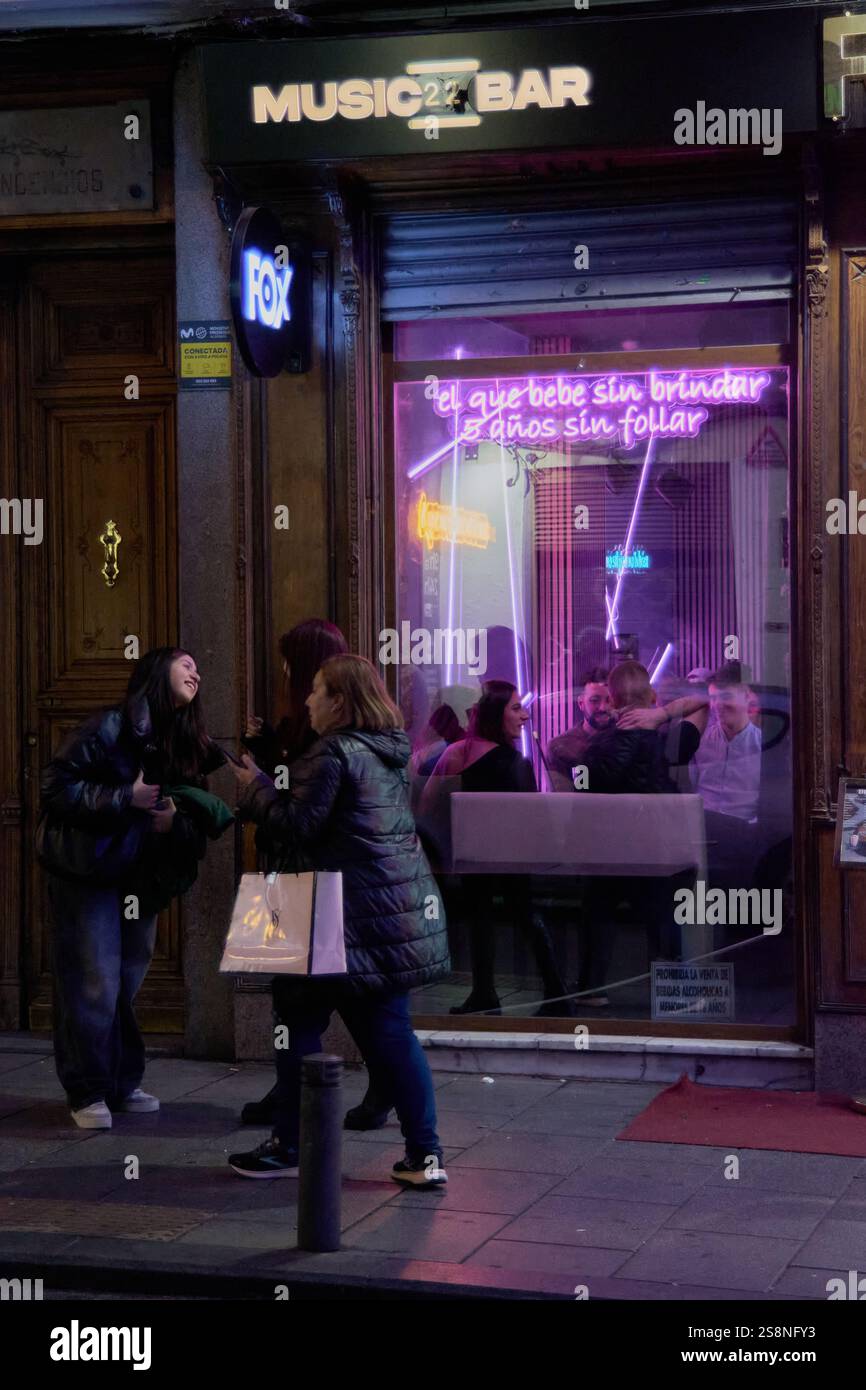 Madrid. Spain - January 23, 2025: Nightlife. People standing outside ...