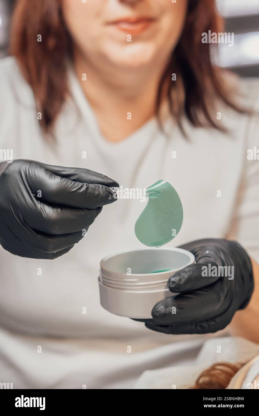 Applying Cooling Eye Patch with Precision Stock Photo - Alamy