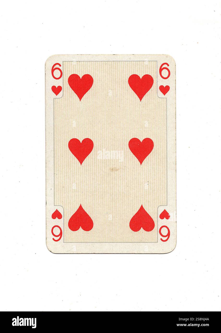 An antique six of hearts playing card isolated on a white background ...
