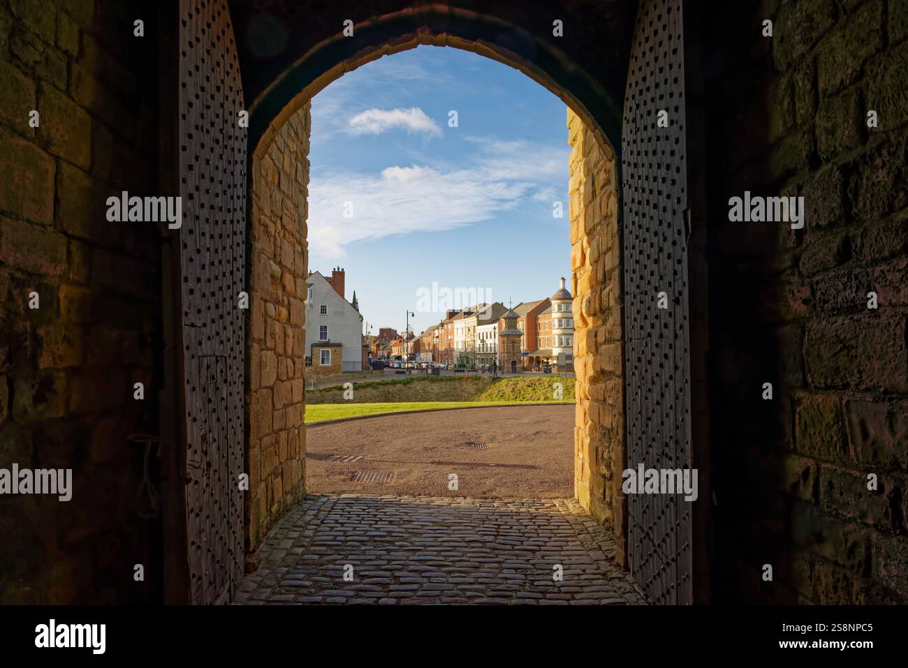Tynemouth town centre framed by the arch of Tynemouth Castle gateway ...