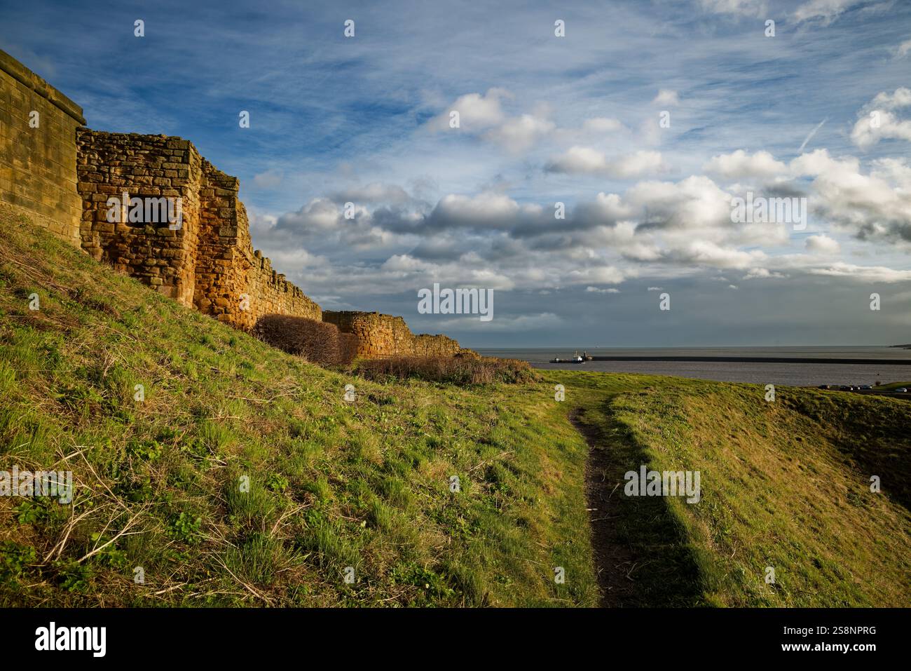 The walls of Tynemouth Castle on the headland above the mouth of the ...