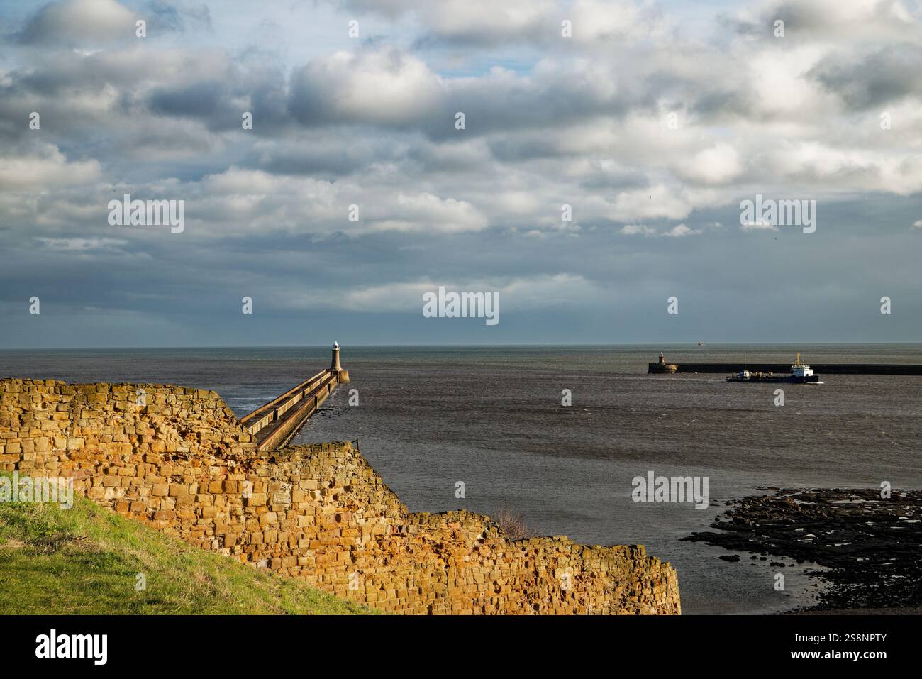 The walls of Tynemouth Castle witness another ship leaving the mouth of ...