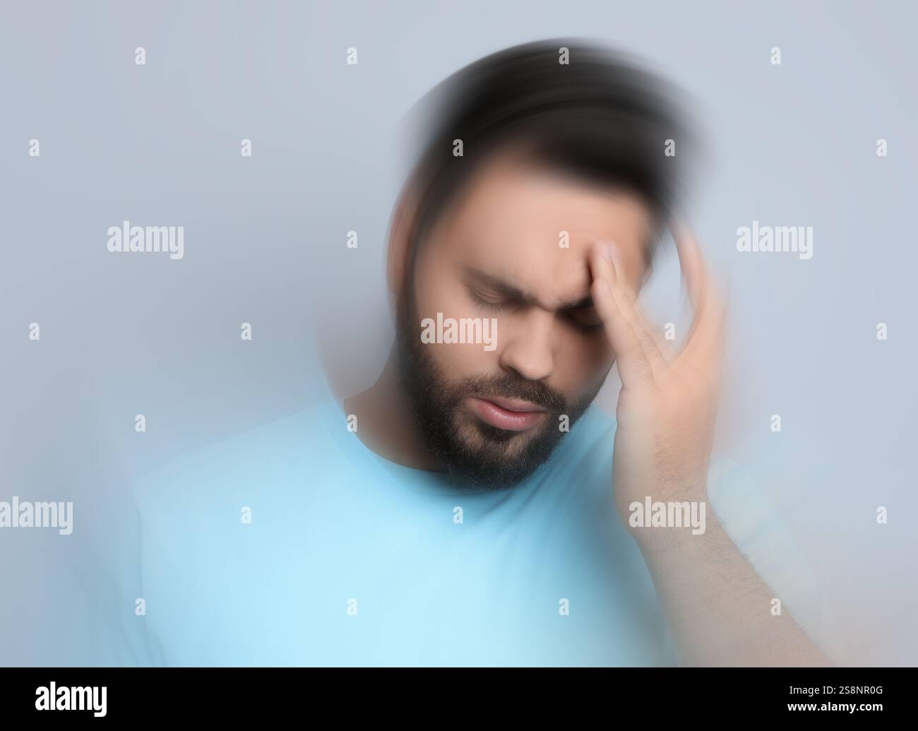 Man suffering from headache and dizziness on grey background Stock ...