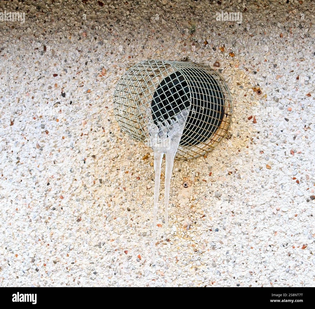 Boiler exhaust vent with large icicle hanging down Stock Photo - Alamy