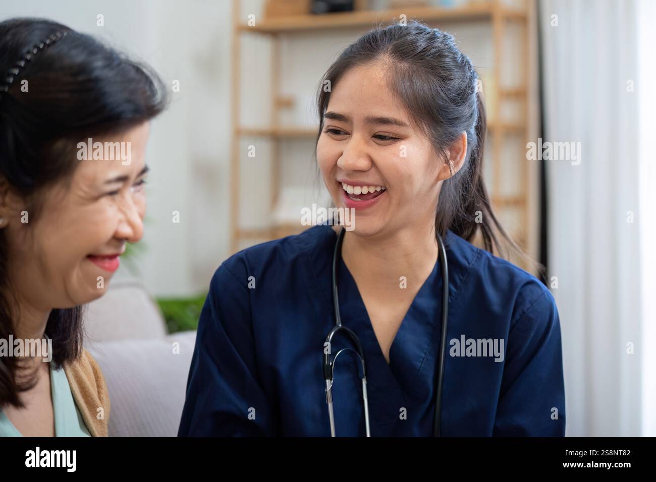 Elderly patient enjoying a positive interaction with caregiver during ...