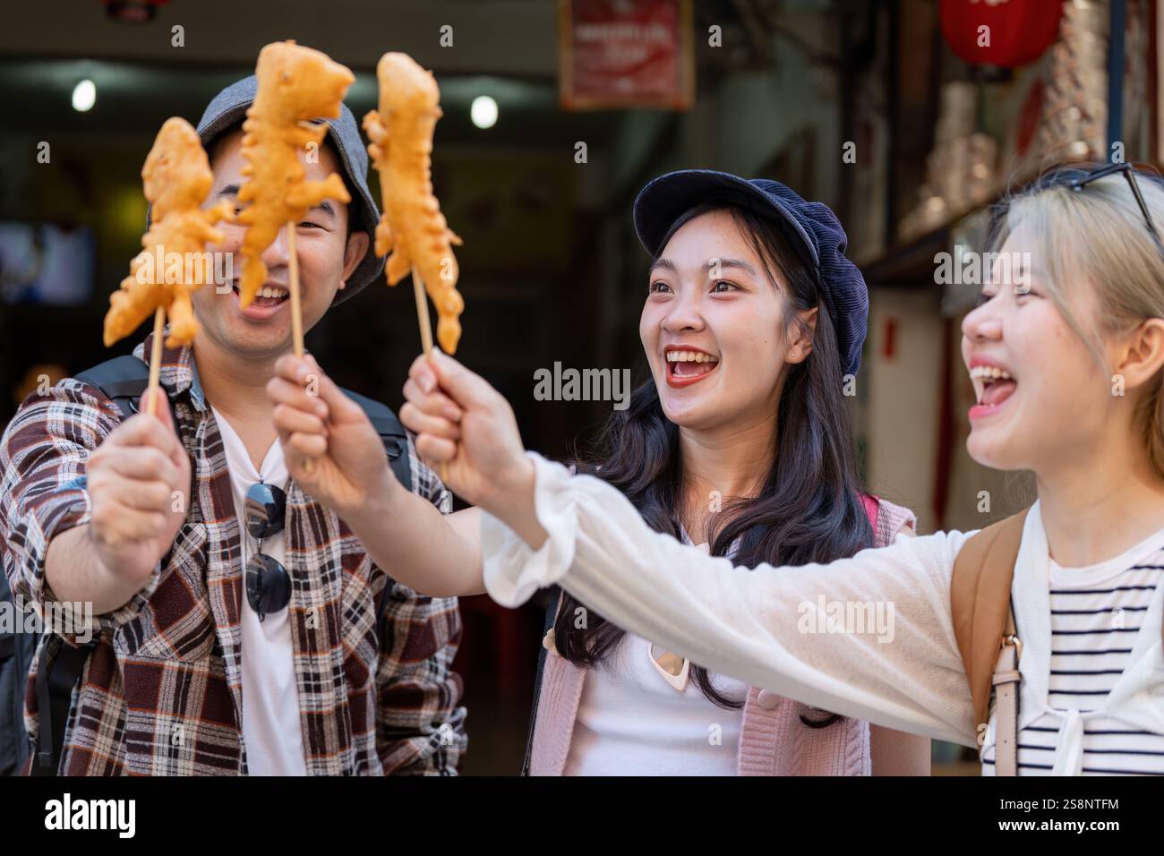 Friends enjoying local delicacies, joyfully sharing street food snacks ...