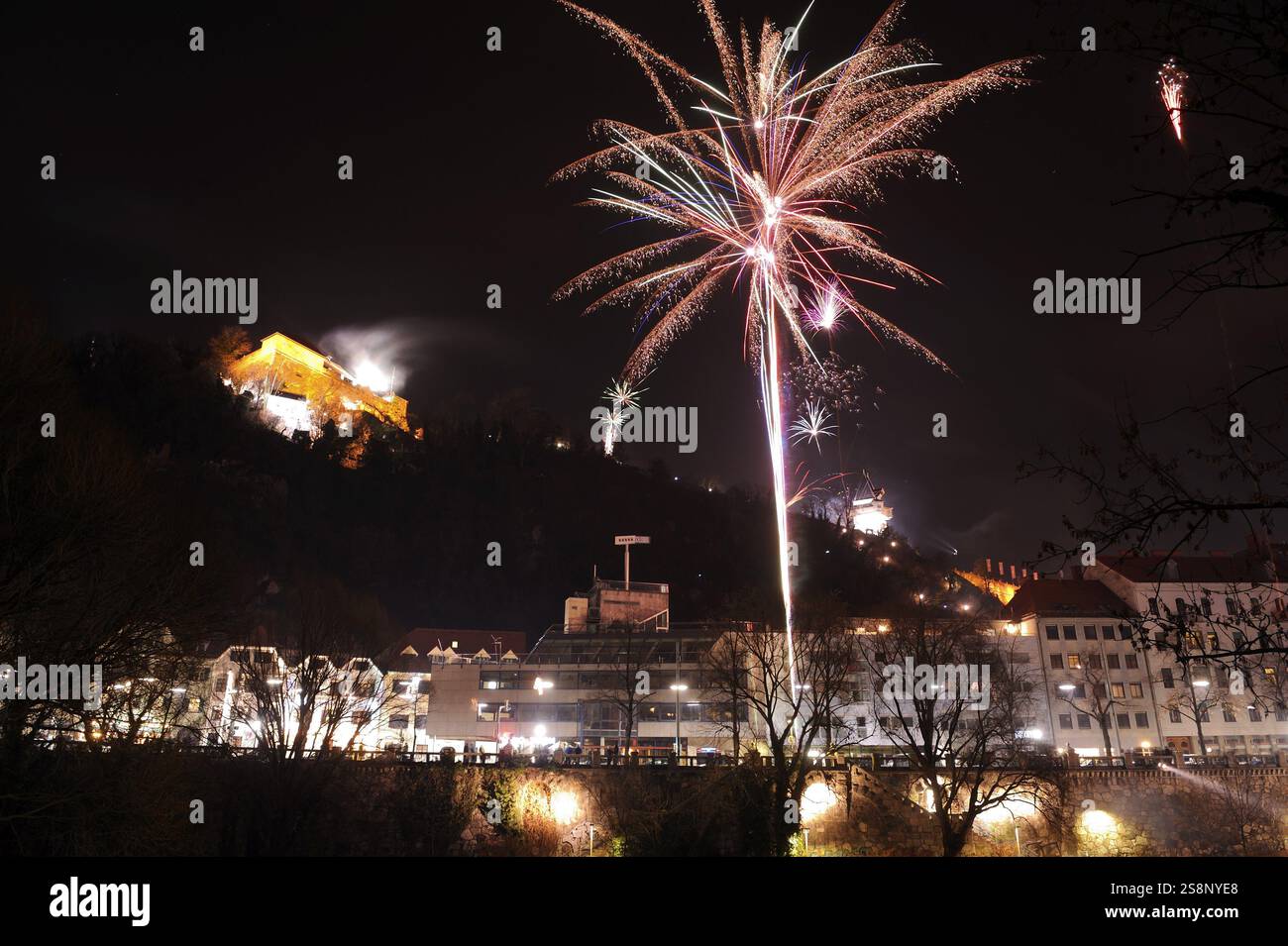 Urban surroundings lit up by spectacular firework rockets in the night ...