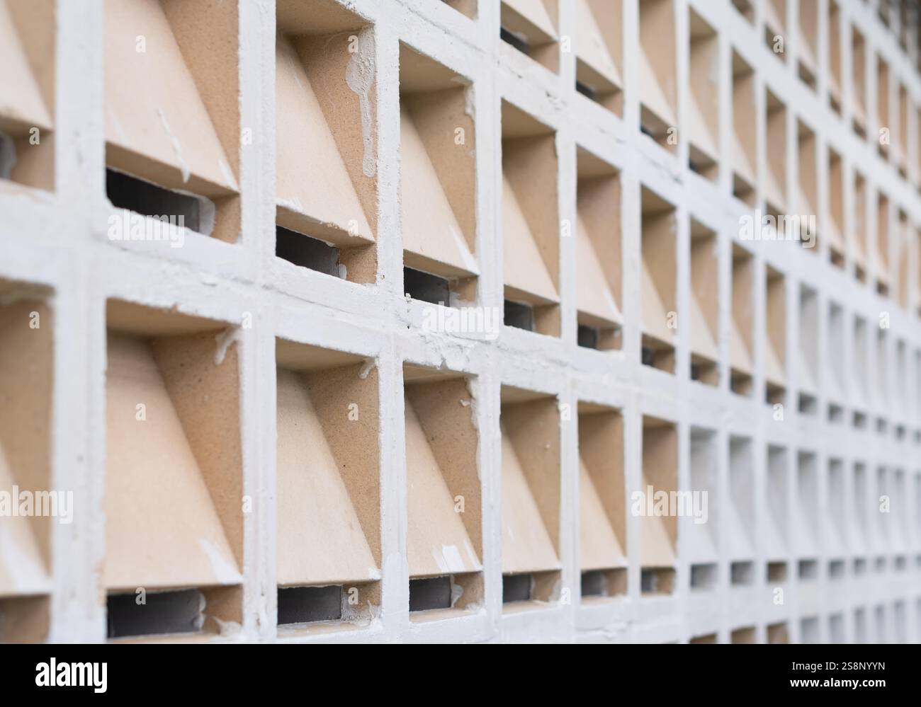 A close-up view of a textured wall made of concrete blocks with ...