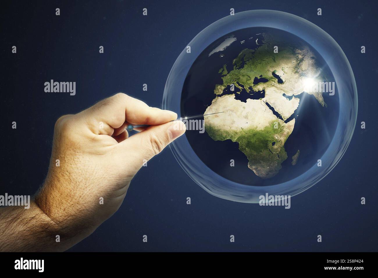 Planet earth in a soap bubble and a hand with a needle that bursts ...