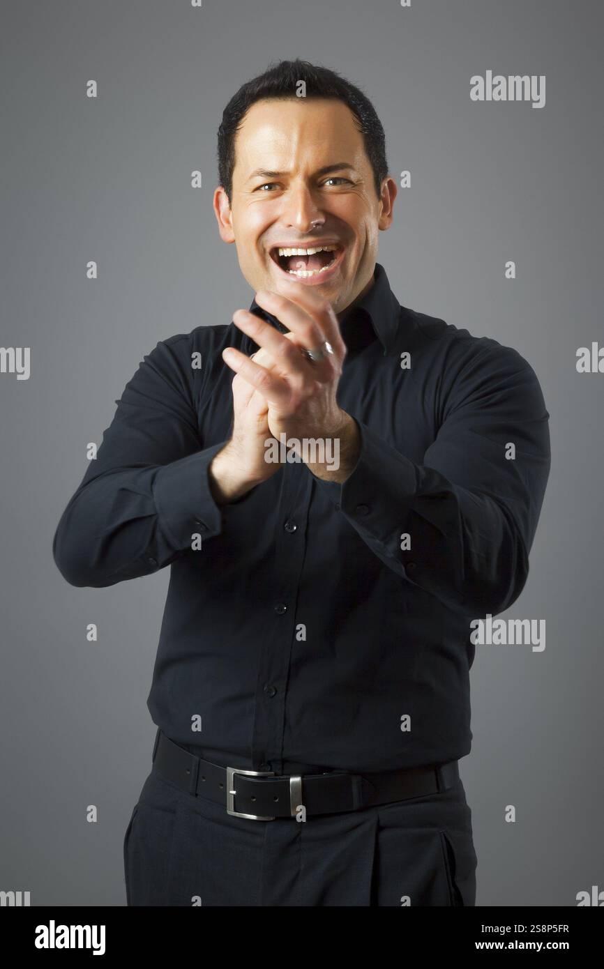 An image of a handsome man claps his hands Stock Photo - Alamy