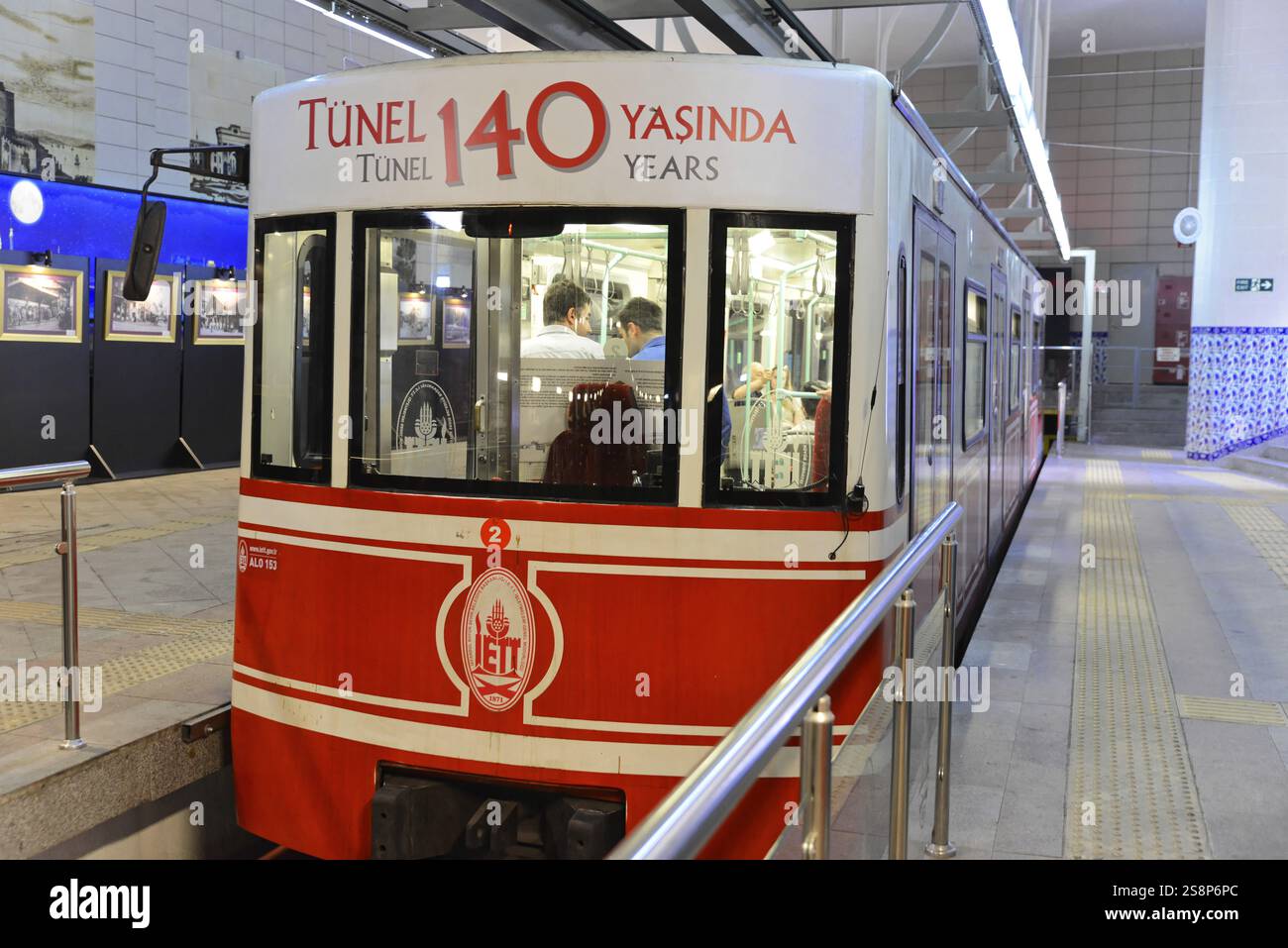 Train in a modern tunnel station, striking red and white colours ...