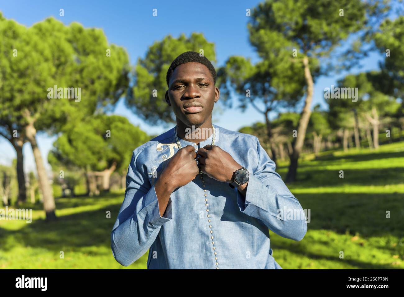 Young senegalese man wearing traditional dashiki attire, posing in a ...