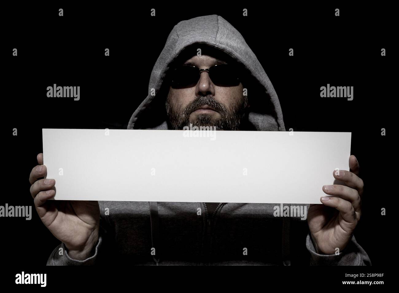 An image of an unrecognizable man in the dark with a white board Stock ...
