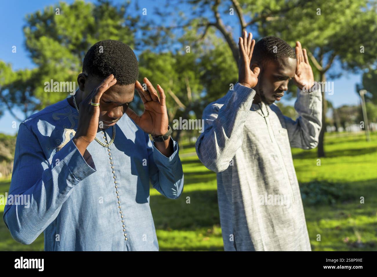 Two young senegalese men wearing traditional dashiki clothing are ...