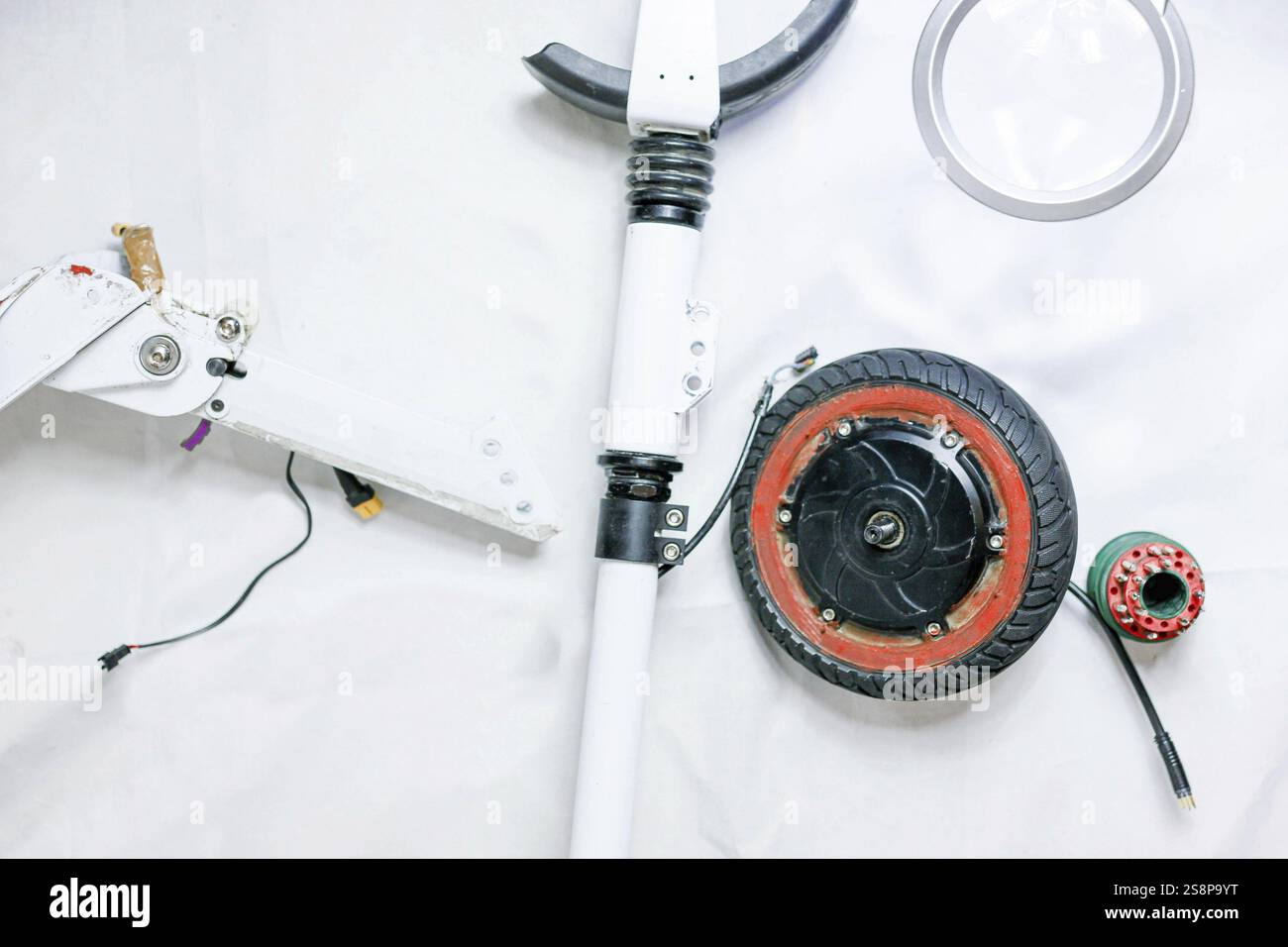 Scooter components including wheel and frame spread out for assembly ...