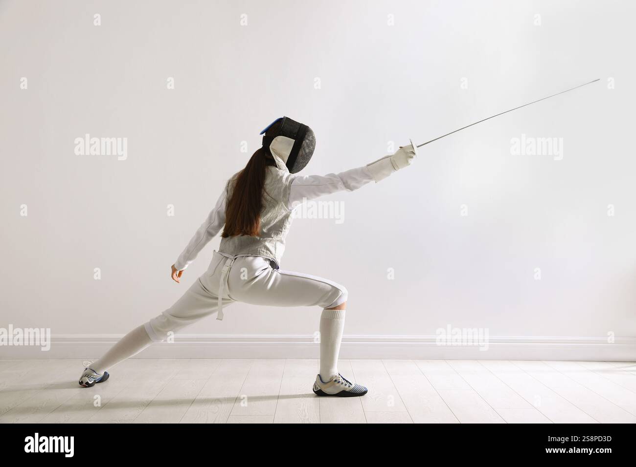 Fencer with epee practicing indoors. Combat sport Stock Photo - Alamy