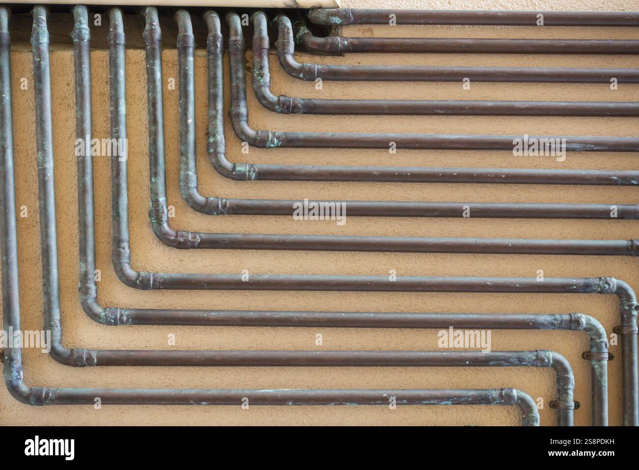 An image of some copper tubes outside on a wall Stock Photo - Alamy