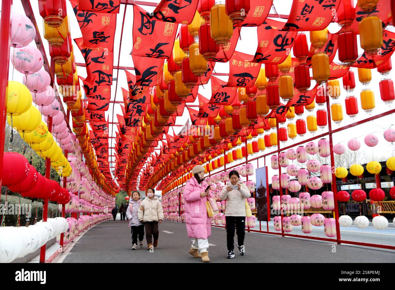 LIANYUNGANG, CHINA - JANUARY 23, 2025 - Tourists view festive lanterns ...