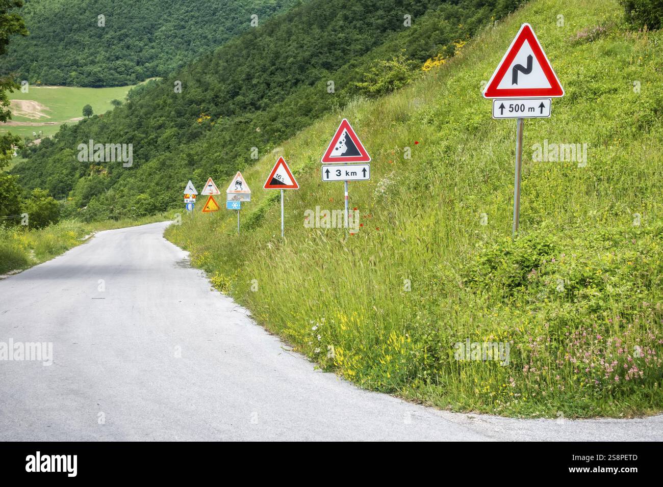 An image of some street signs on a steep road Stock Photo - Alamy
