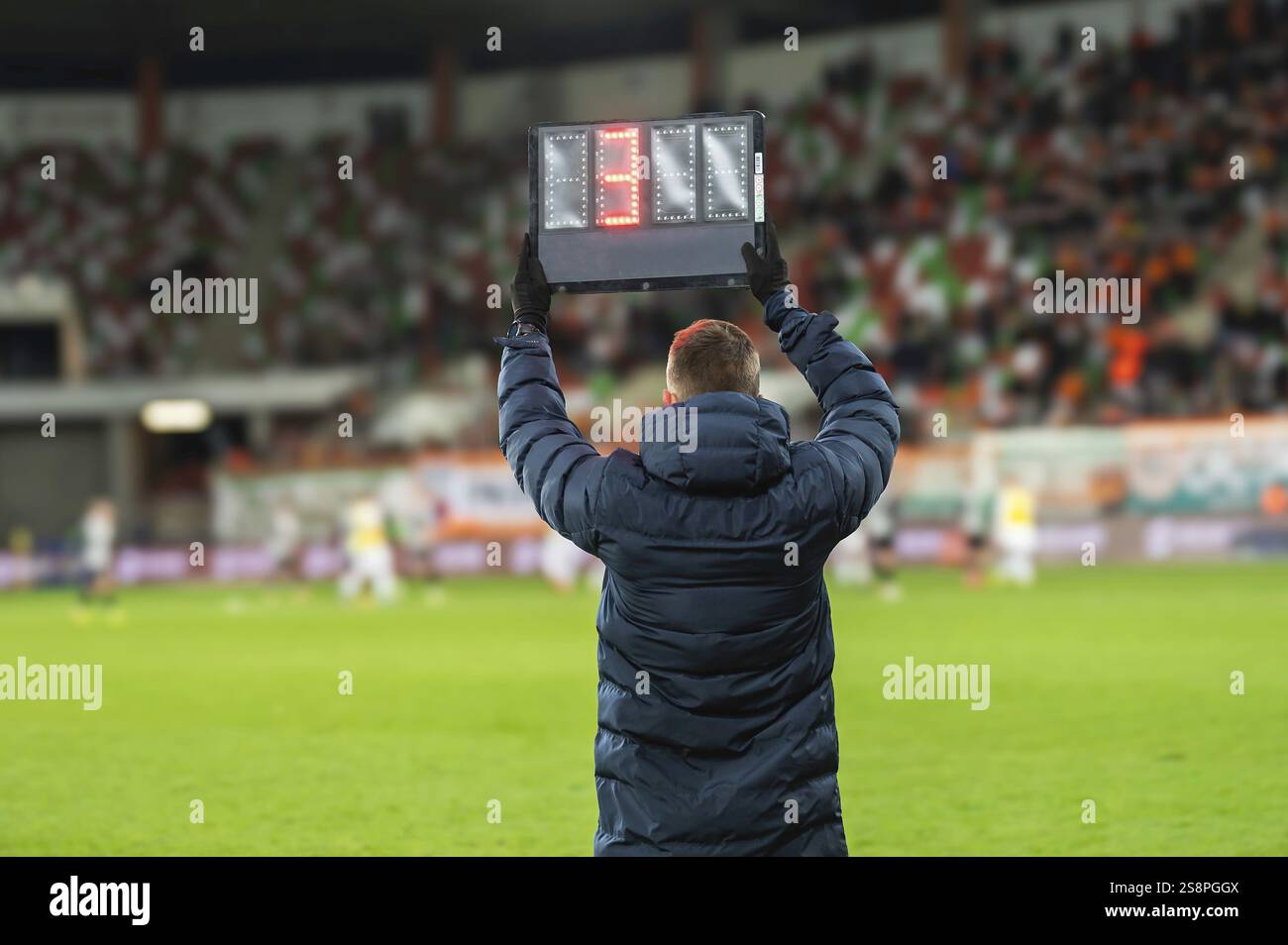 Technical referee shows added time during football match. seven, black ...