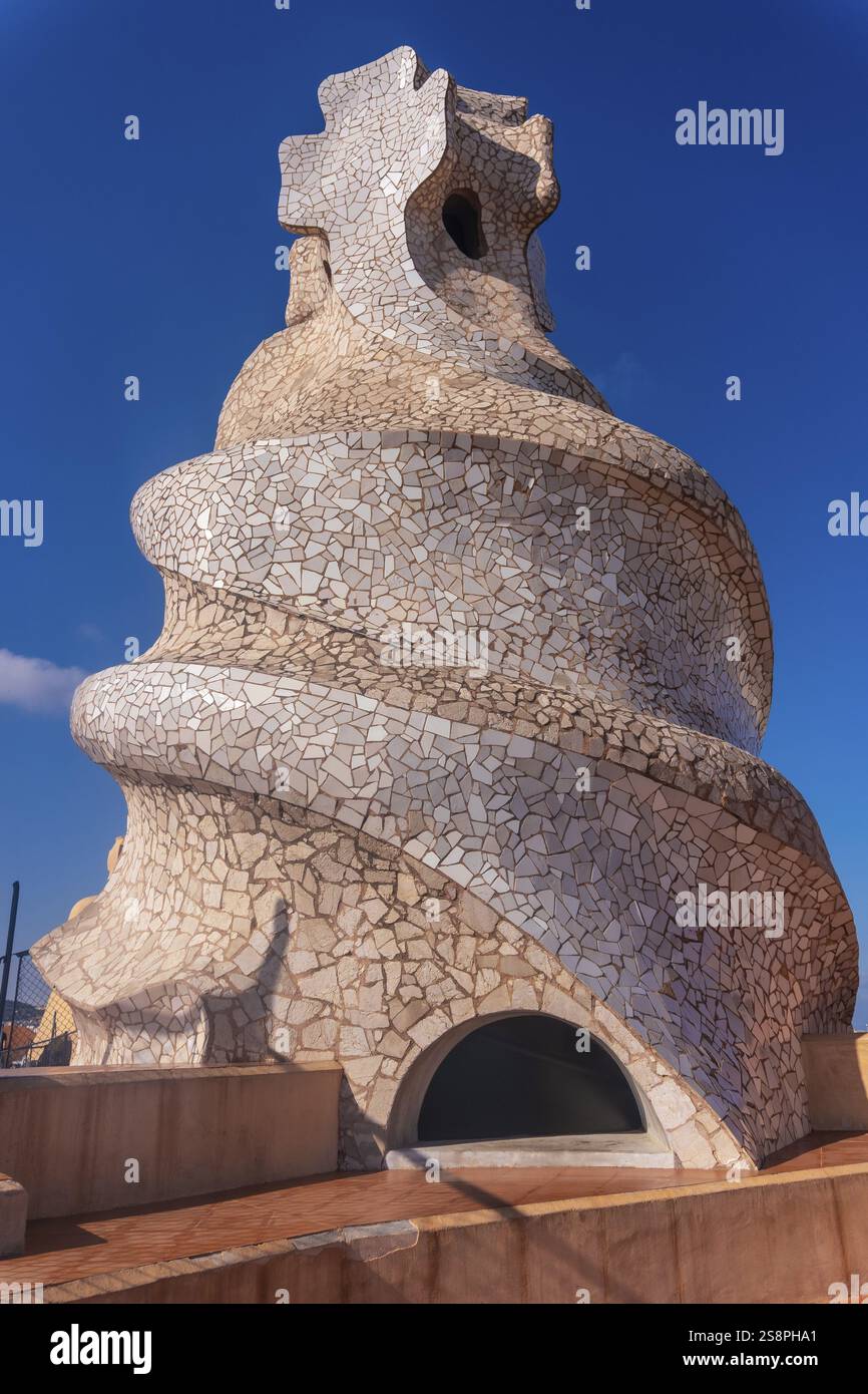 Whimsical chimney covered in colorful mosaic tiles stands out against a ...