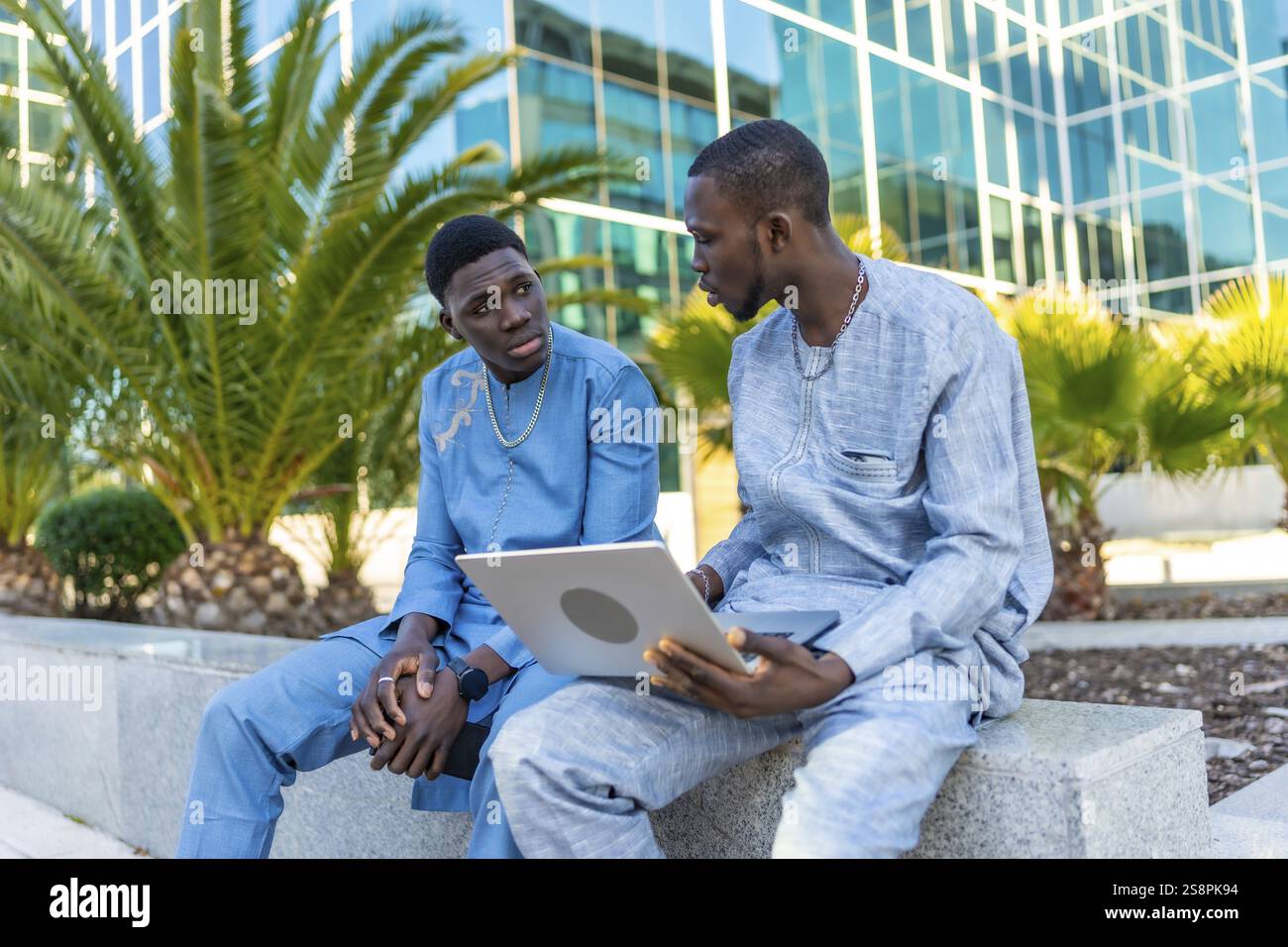 Two senegalese businessmen wearing traditional dashiki attire are ...