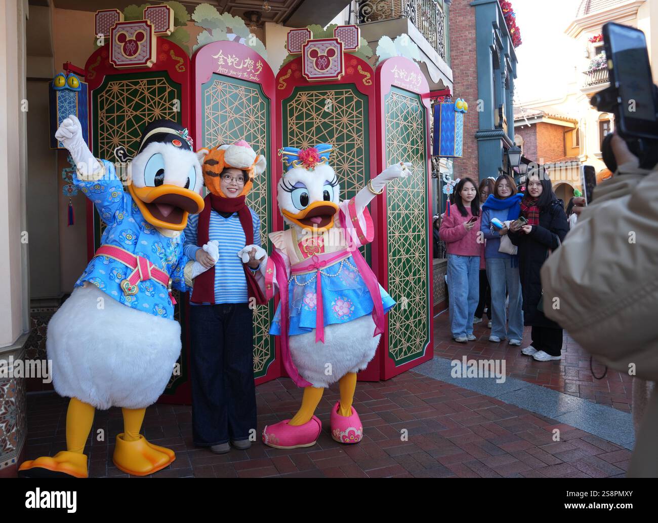 Beijing, China. 22nd Jan, 2025. Tourists pose for pictures at Shanghai ...